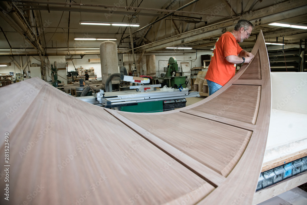 Carpenter working on curved cabinet face in workshop Stock Photo ...