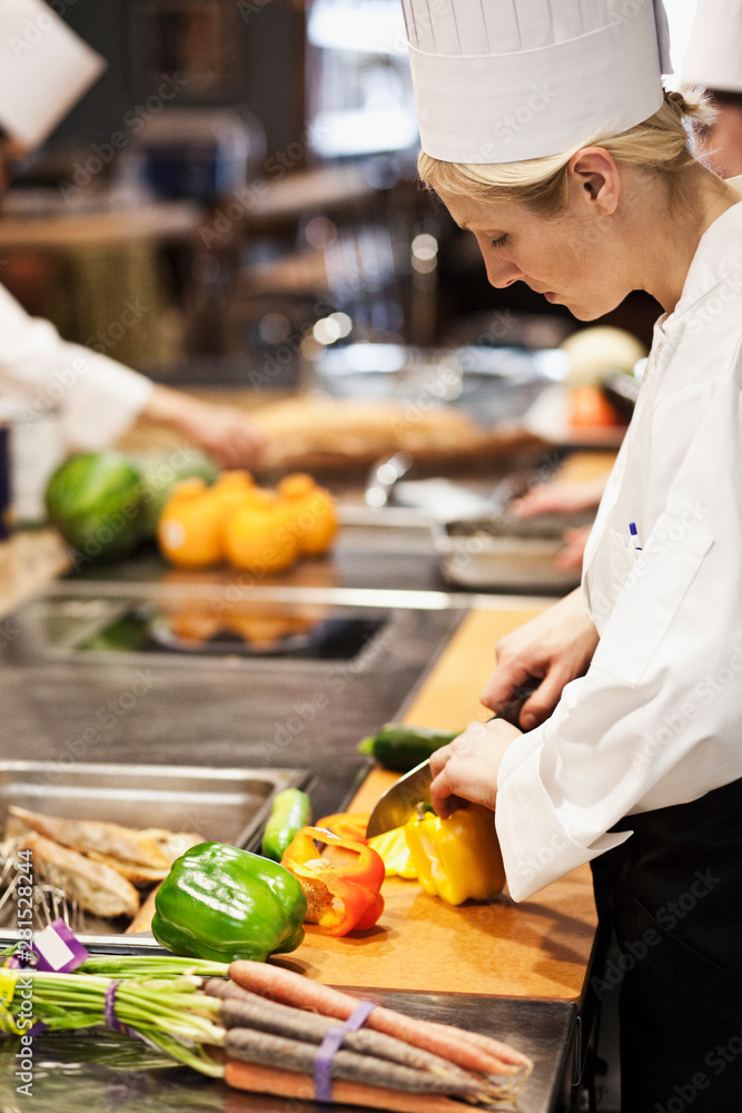 Chef cutting vegetables in commercial kitchen Stock Photo | Adobe Stock