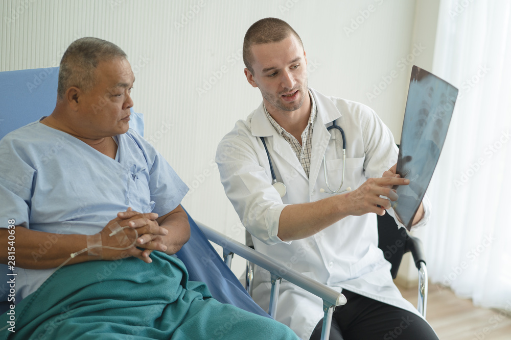 Doctor showing result of radiography to patient and giving diagnosis ...