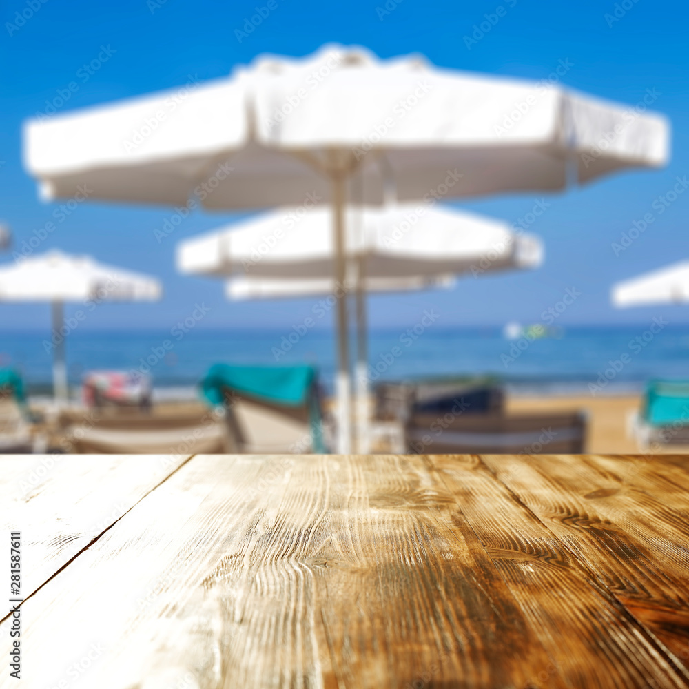 Table background with beautiful blue ocean and sandy beach view. A ...