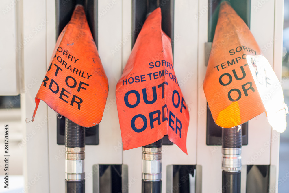 Fuel pumps with a cover signs that read " out of order " at the ...