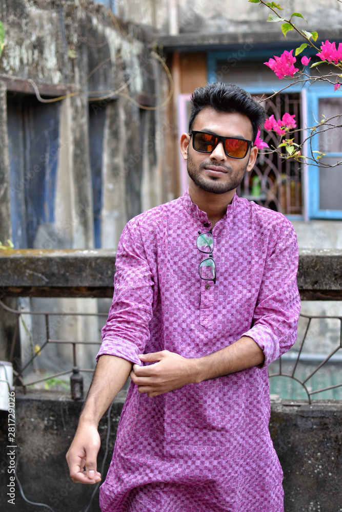 Portrait of a young and handsome Indian Bengali man standing in front ...