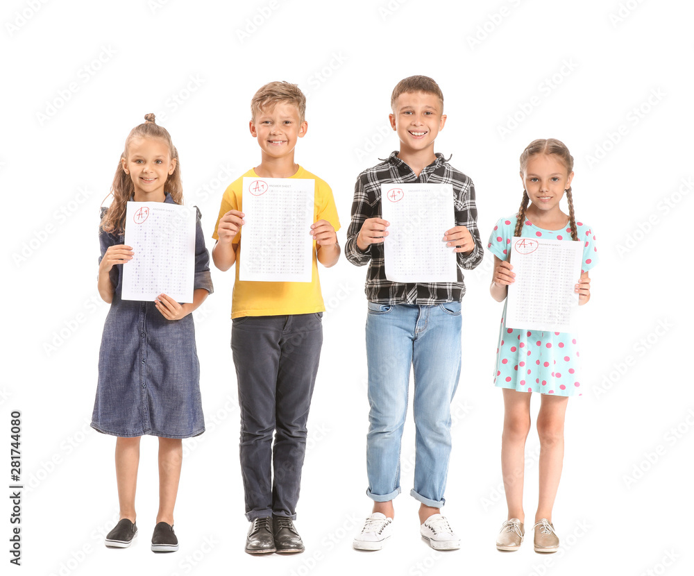 Happy children with answer sheets for school test on white background ...