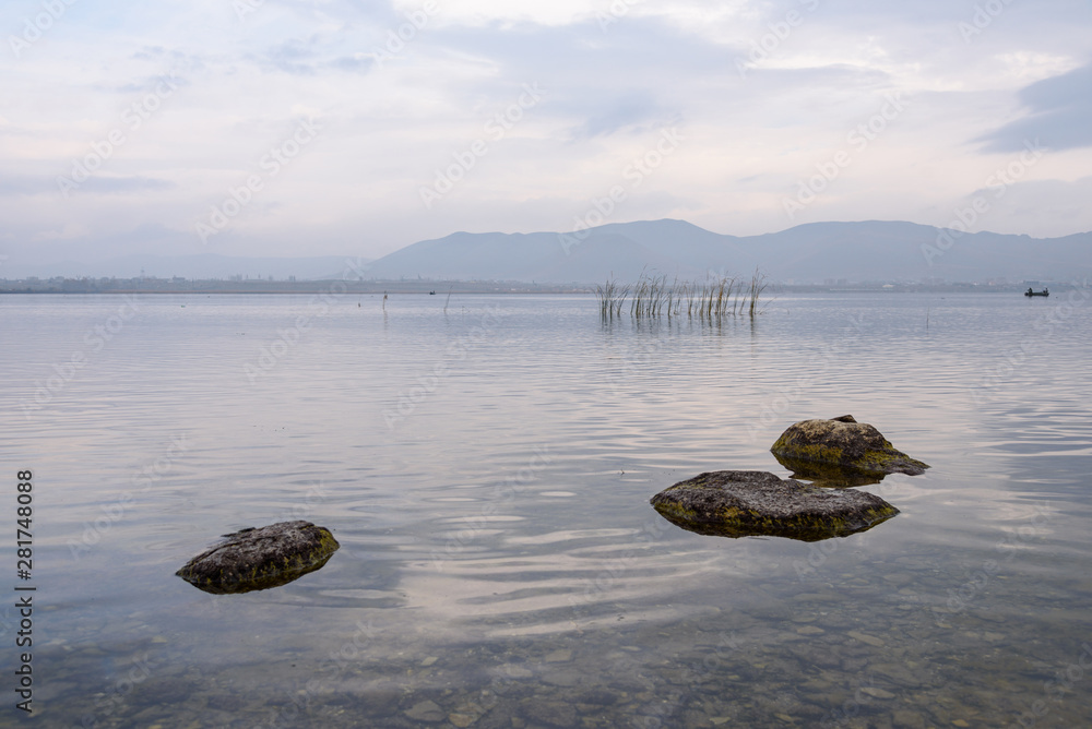 The water expanses of the endless Lake Sevan with stones in the ...