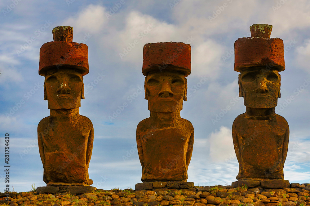 Moai on Easter Island with red topknot hats at Anakena Ahu. Stock Photo ...