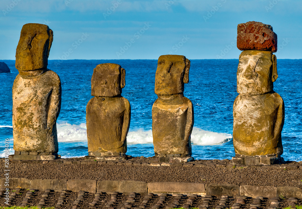 Moai on Easter Island with red topknot hats at Anakena Ahu. Stock Photo ...