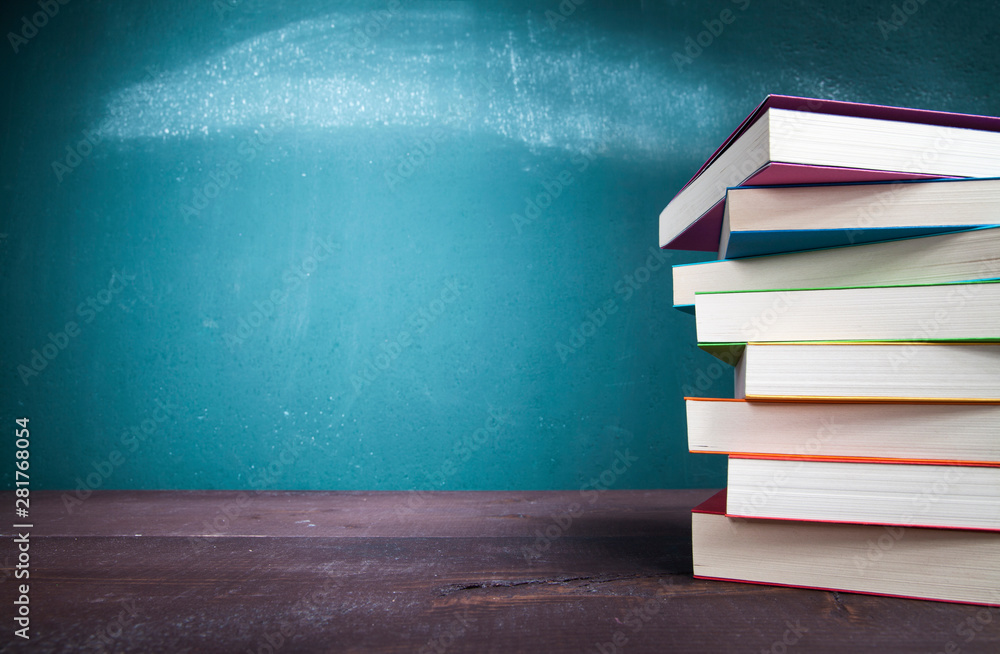 Textbooks on school desk with blackboard Stock Photo | Adobe Stock