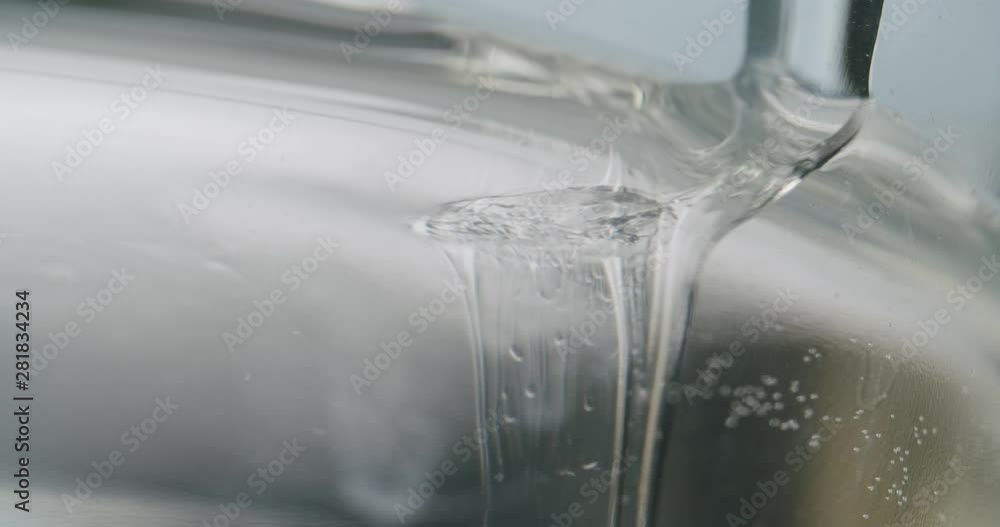 Threads of liquid viscous syrup streaming down in water. Syrup and ...