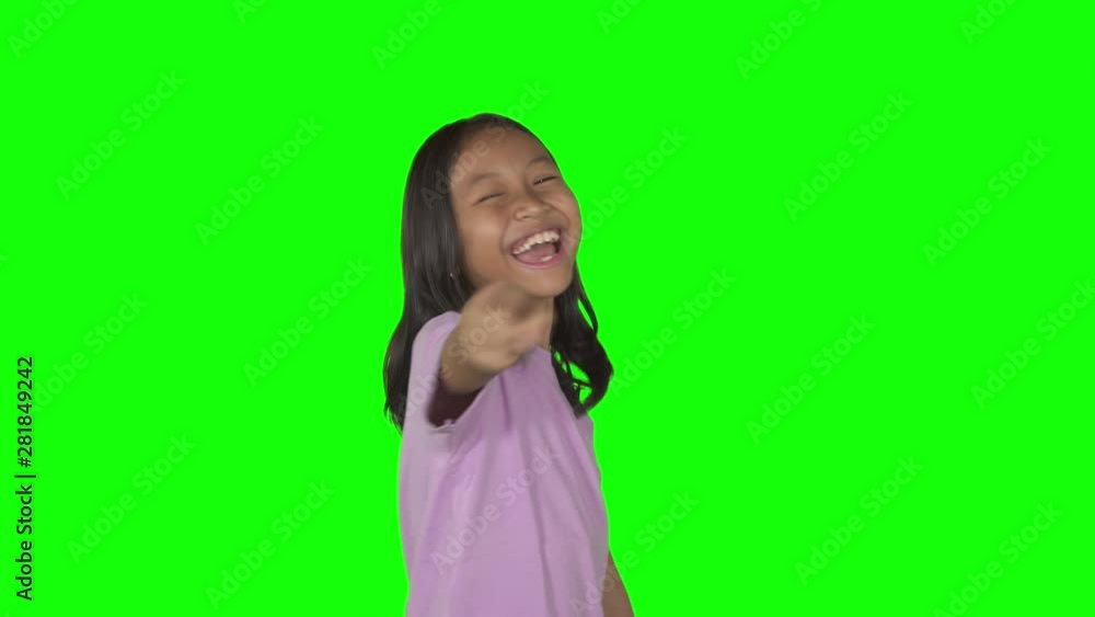 Little girl laughing and pointing at the camera looks bullying or ...