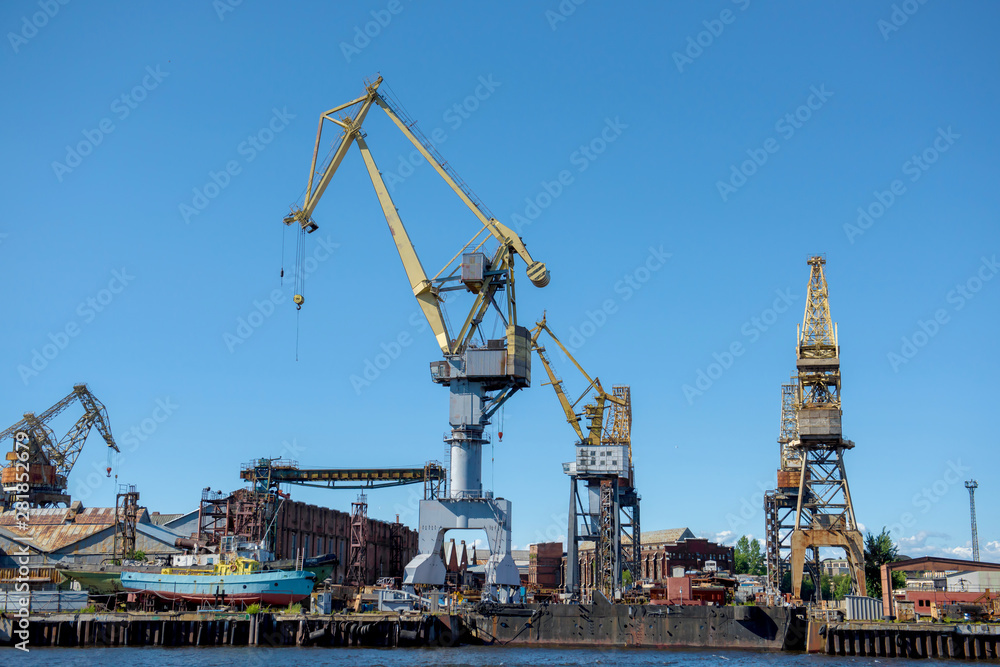 Loading cranes at the sea port. Cargo transportation by ships. Stock ...
