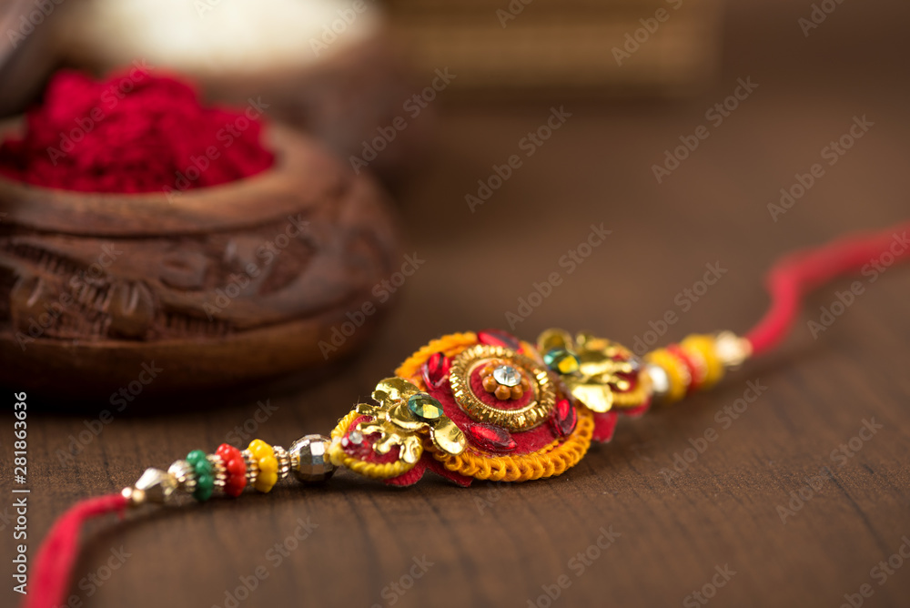 Indian festival: Raksha Bandhan background with an elegant Rakhi, Rice ...