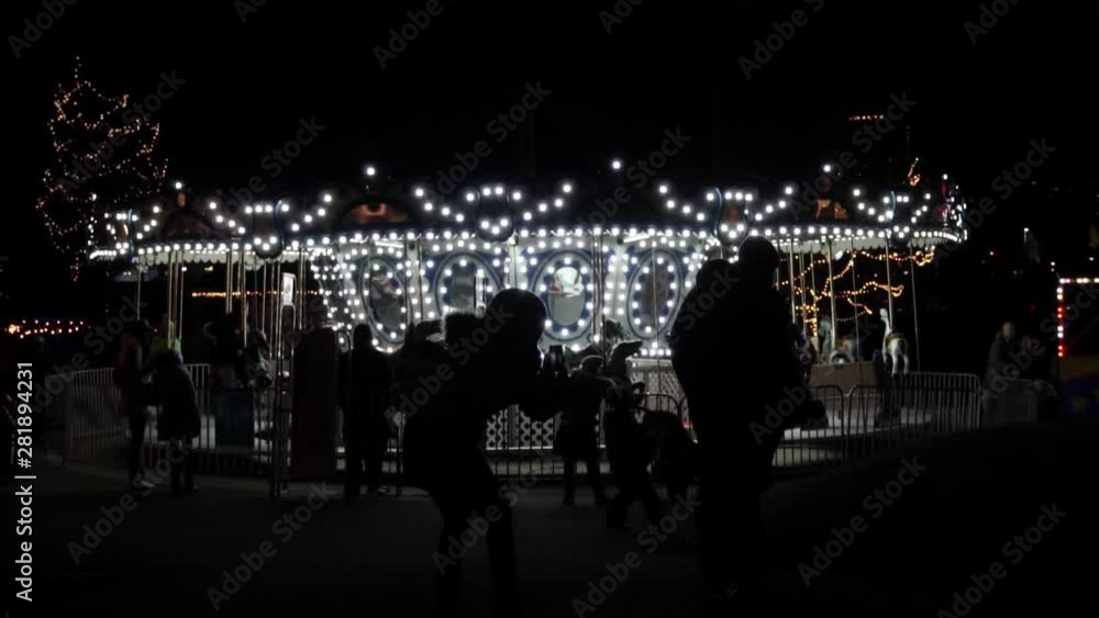 Brightly lit flashing light vintage carousel at winter light festival ...