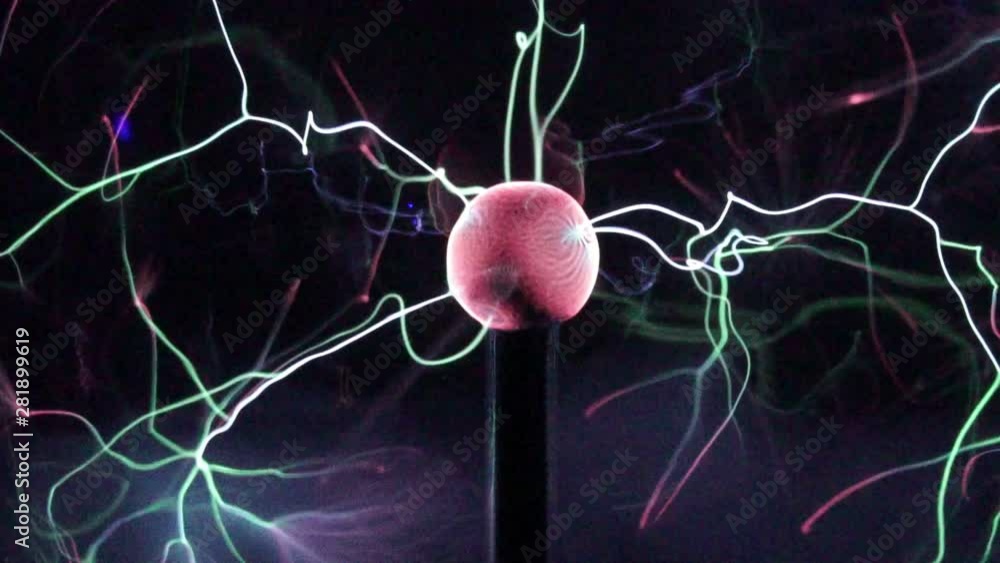 Plasma ball lamp close up, moving electric rays from the ball on black ...