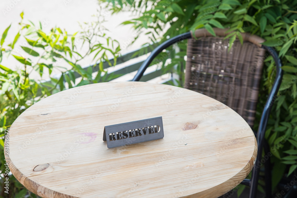 Table reservation sign close up. Reserved sign on summer restaurant ...