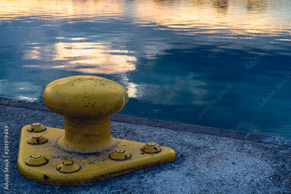 harbor bollard, anchor for ship berthing at quay wall on sky sunset ...