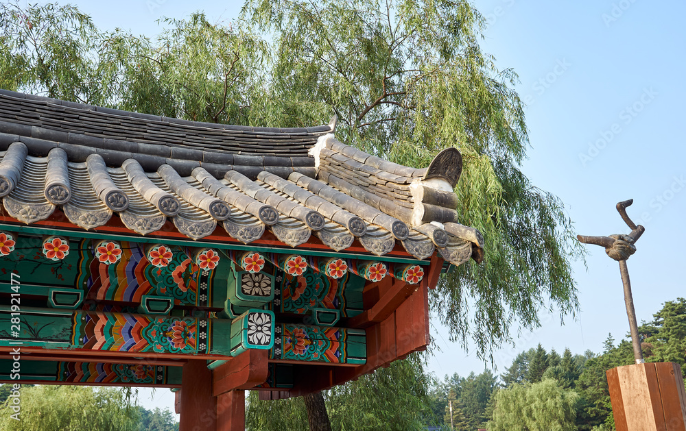 A view of a wooden door with traditional kiwa and colorful decorations ...