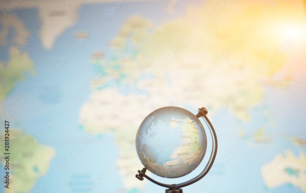 Glass globe on a stand on a map background with rays. Planet earth ...
