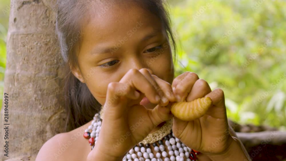 Tribal Child Girl Watching At Juicy Larvae Worms And Eat Into The ...