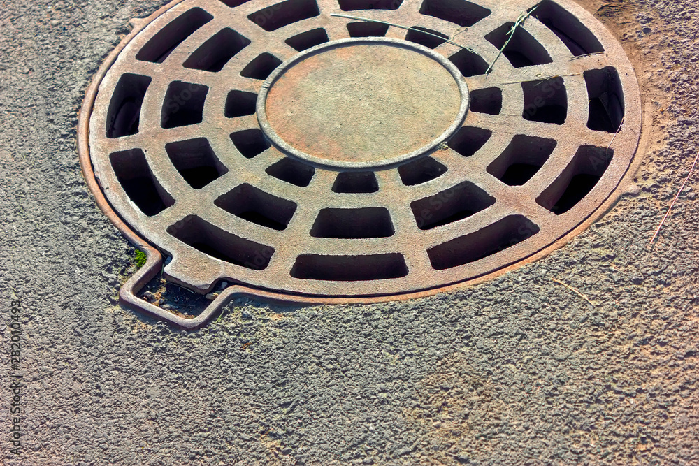 Cast-iron manhole of the storm sewer system in the park. Stock Photo ...