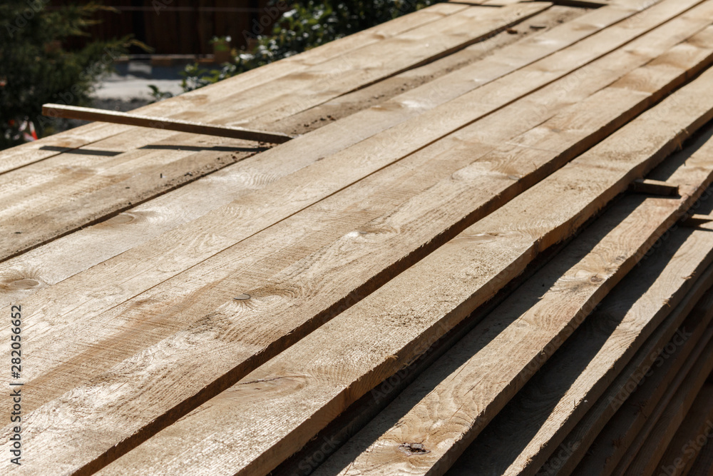 chopped and roughly finished boards, side view close-up. Natural Wood ...