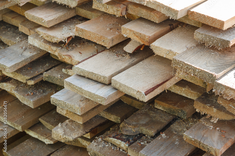 stacked Wooden planks with spruce background, boards for construction ...