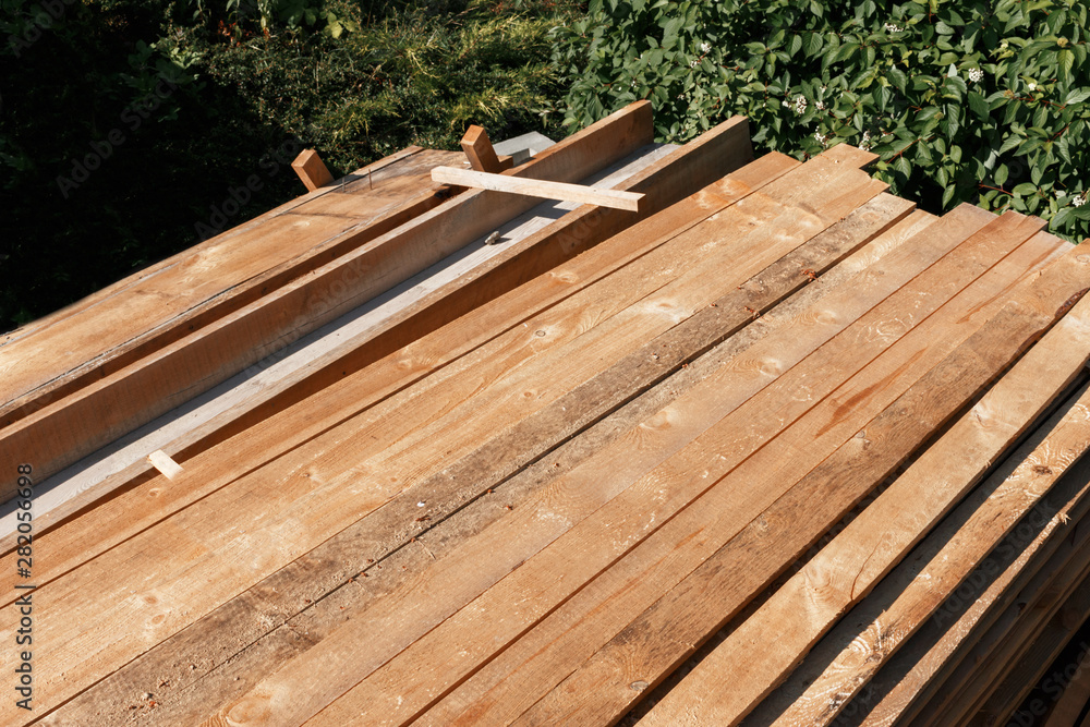 Wooden planks, boards for construction works. wooden planks lie in rows ...