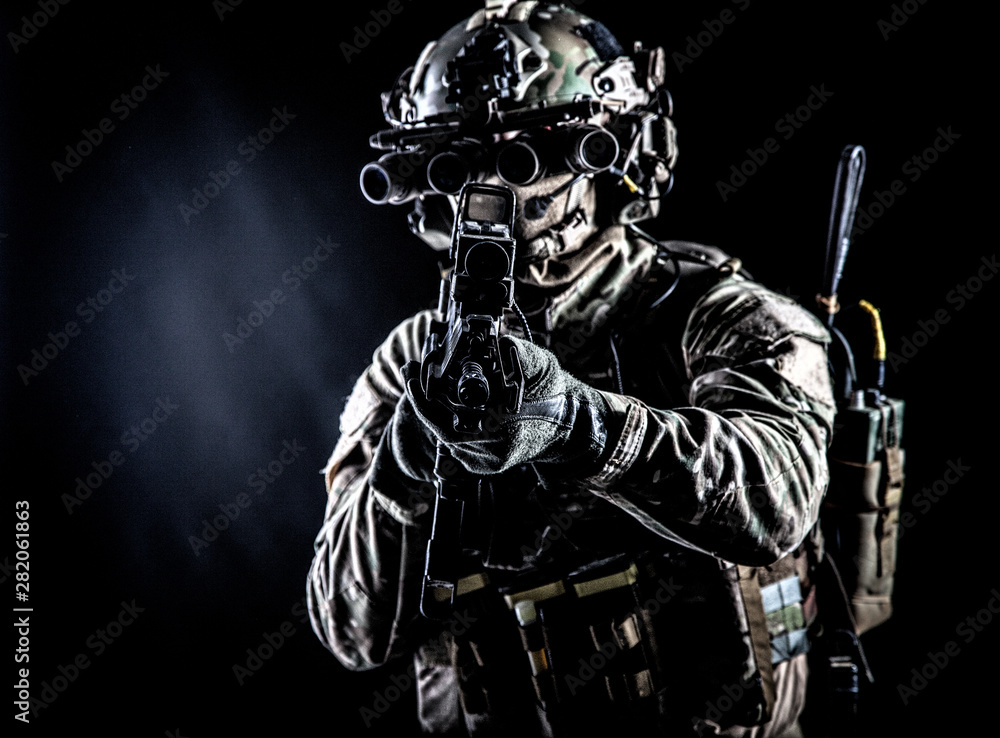 Army soldier aiming rifle in camera in darkness Stock Photo | Adobe Stock