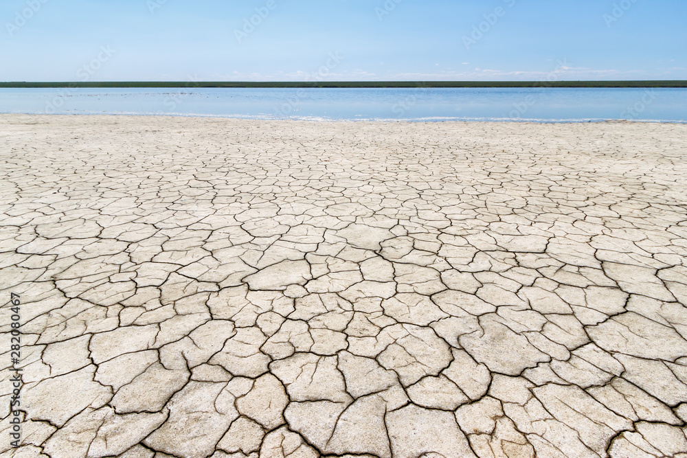 The waterside of the salt lake with dry cracked soil. Gruzskoe lake ...