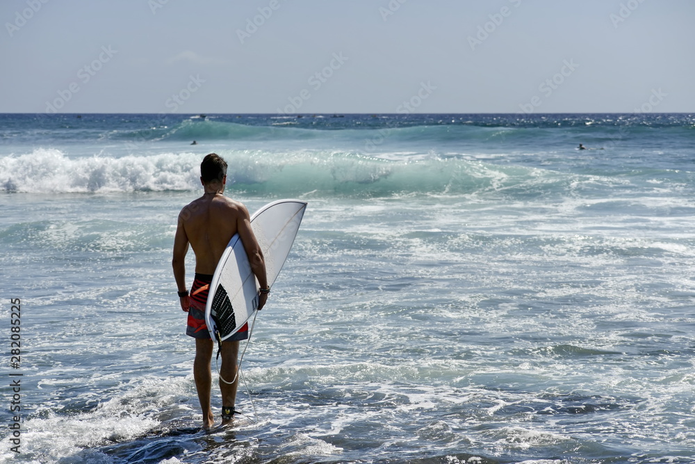 Young pro surfer surfs a big barrel wave in popular surf spot in ...