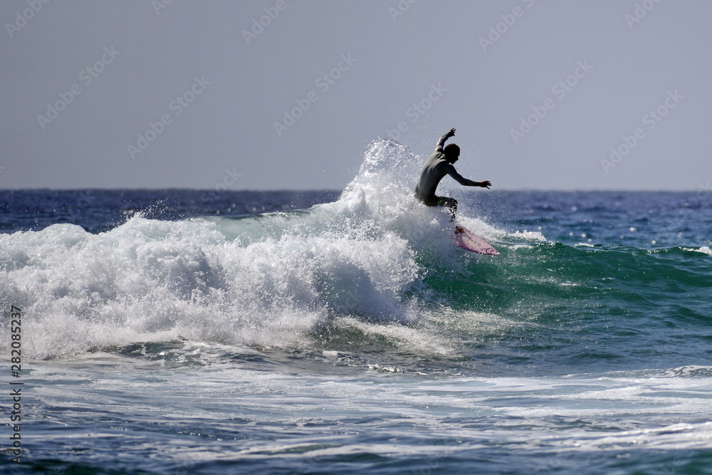 Young pro surfer surfs a big barrel wave in popular surf spot in ...