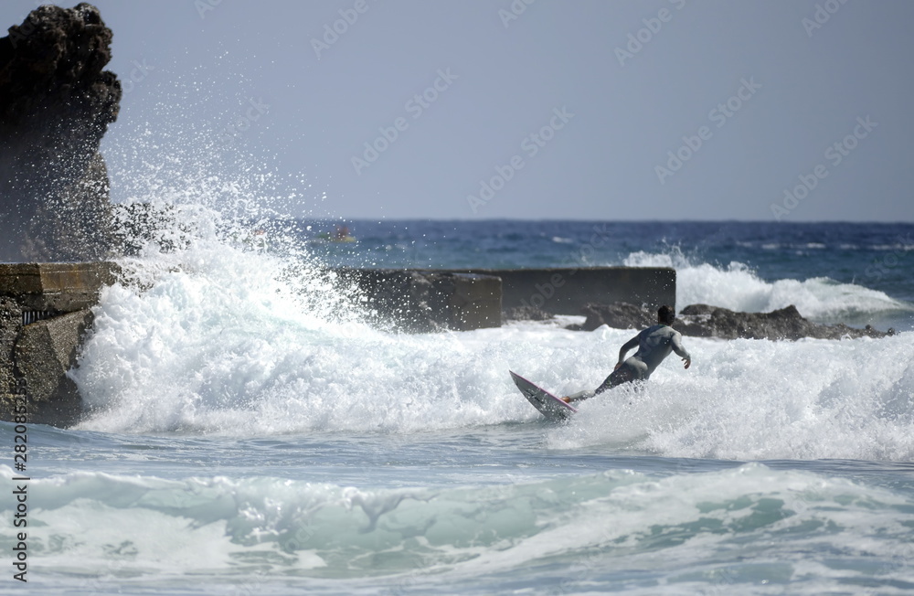 Young pro surfer surfs a big barrel wave in popular surf spot in ...