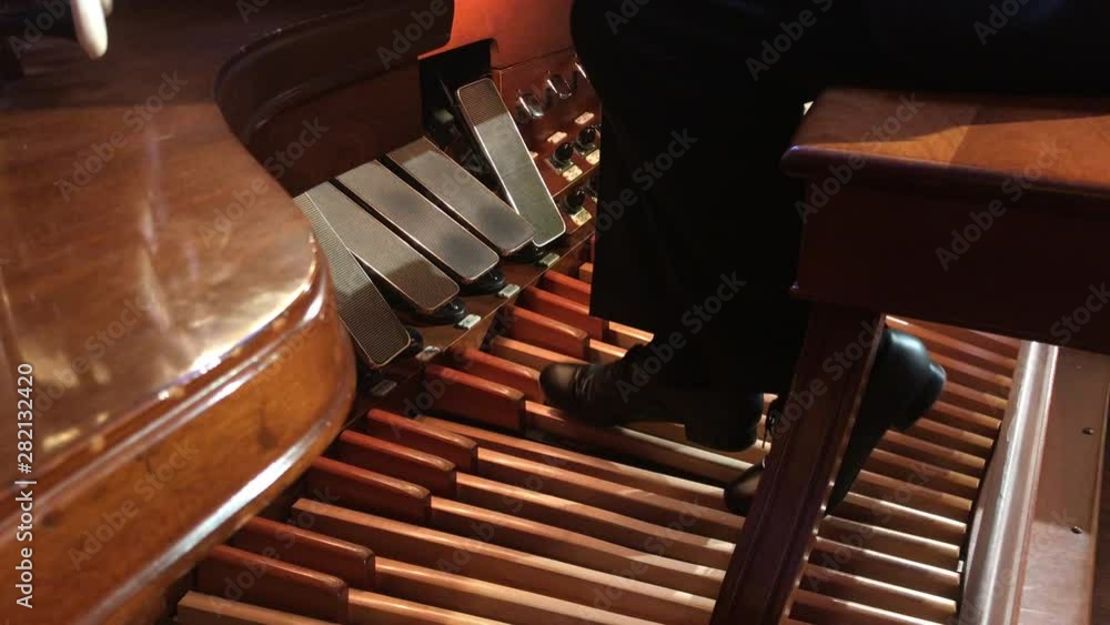 Master organ player using the foot pedals of a pipe organ with amazing ...