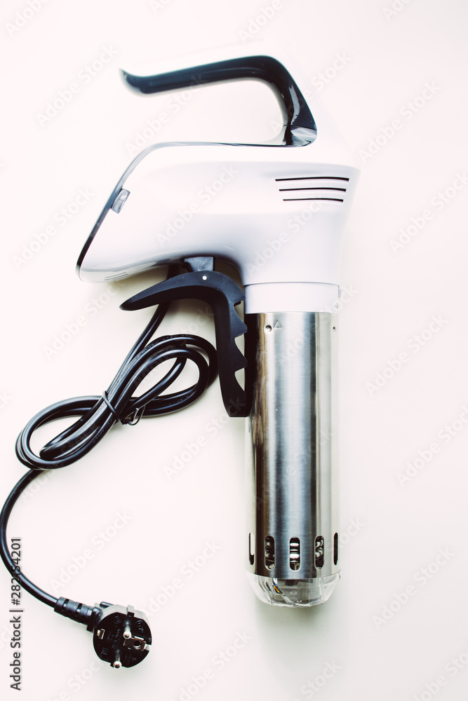 Sous vide stick or rooner close up, top view of a modern utensil for ...