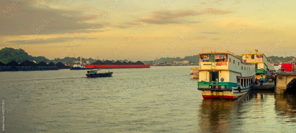 the traffic at Mahakam river, Samarinda, Borneo, Indonesia. tugboat ...