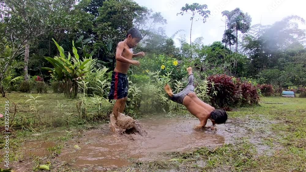 Indigenous Children Playing In A Puddle Of Water In Ecuador Stock Video ...
