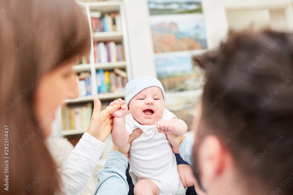 Baby reaches for the hand of the mother Stock Photo | Adobe Stock