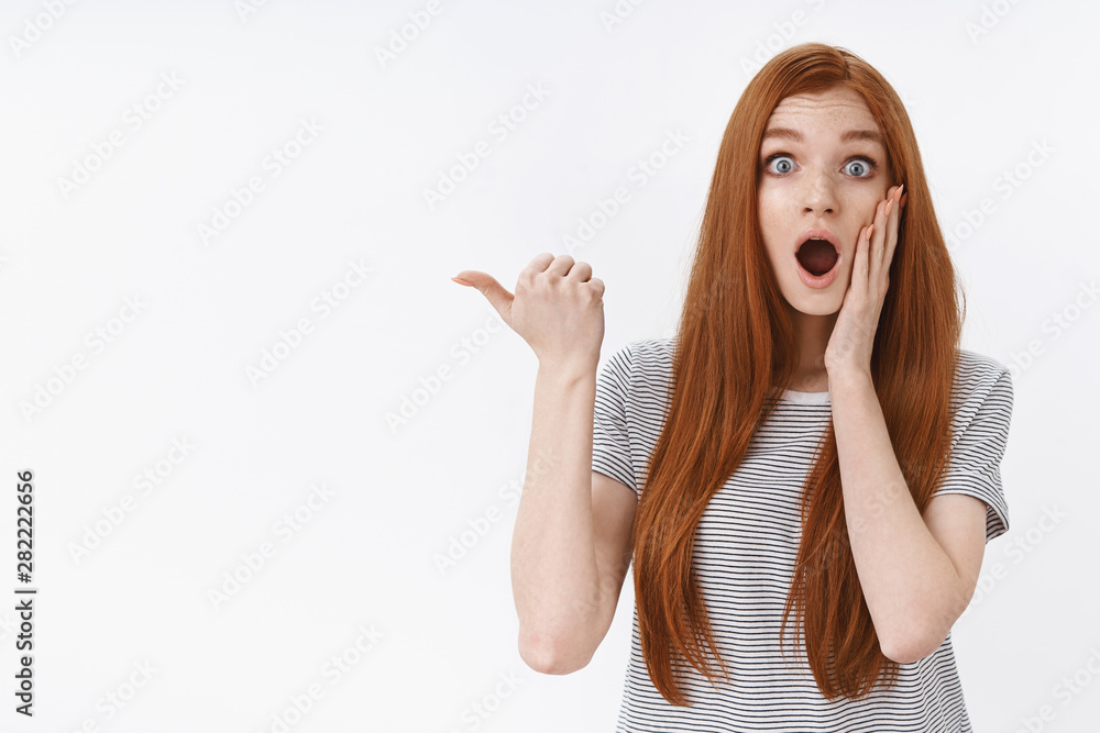 Shocked concerned surprised young redhead woman blue eyes drop jaw ...