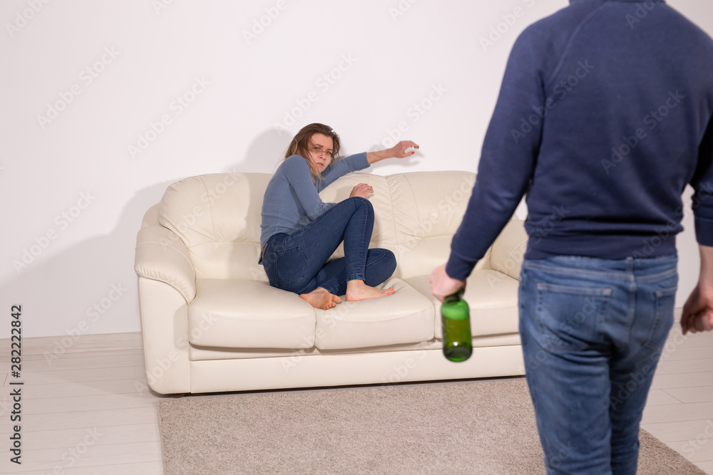 alcoholic, domestic violence and abuse concept - man gets drunk at home and takes his anger at ...