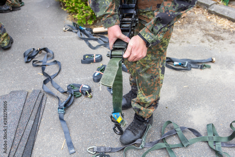 German army soldier holds a lashing ratchet Stock Photo | Adobe Stock