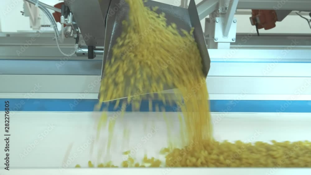 Pasta factory and pasta production stages. Close up of dry macaroni ...
