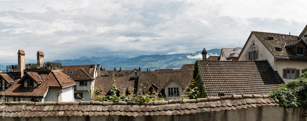 panorama view of old houses and rooftops in Europe with mountain ...