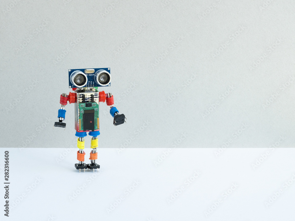 Back to school concept. A metal robot and an electronic board that can ...