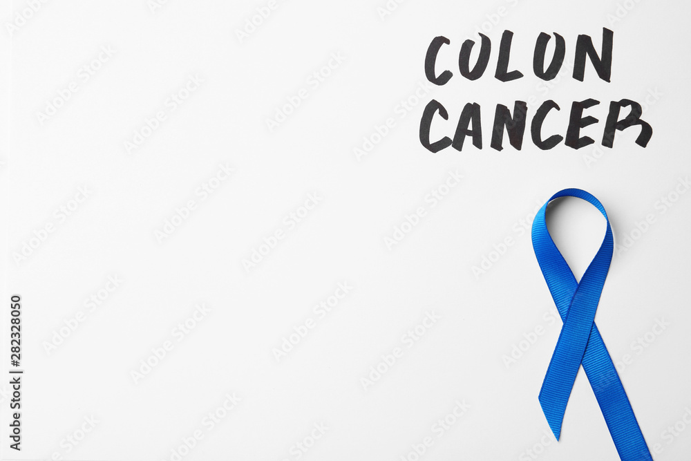Blue awareness ribbon and words COLON CANCER on white background, top ...