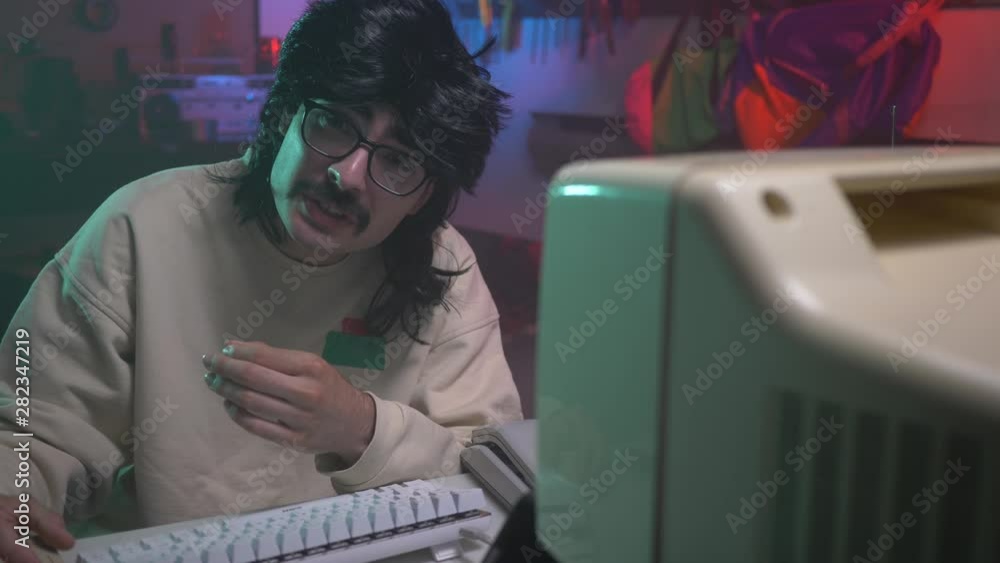 In the '80s or '90s a computer nerd is talking directly to the camera ...