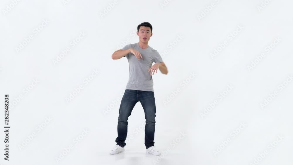 Full length portrait of happy excited young Asian man in casual gray t ...