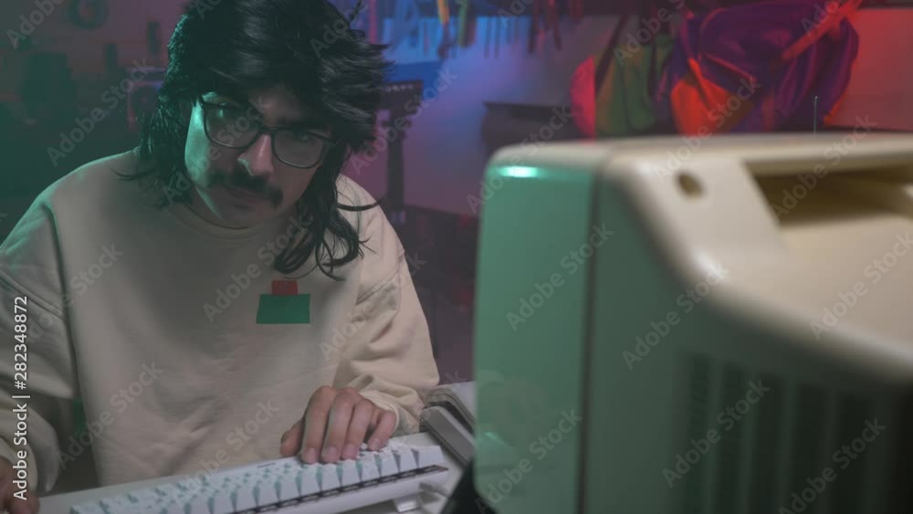 computer nerd in the '80s or '90s looking at the camera. Retro scene ...