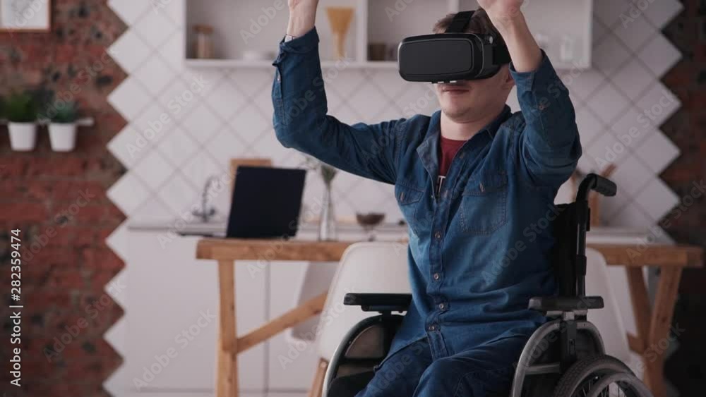 Adult disabled man sitting in special comfort wheelchair and spending ...