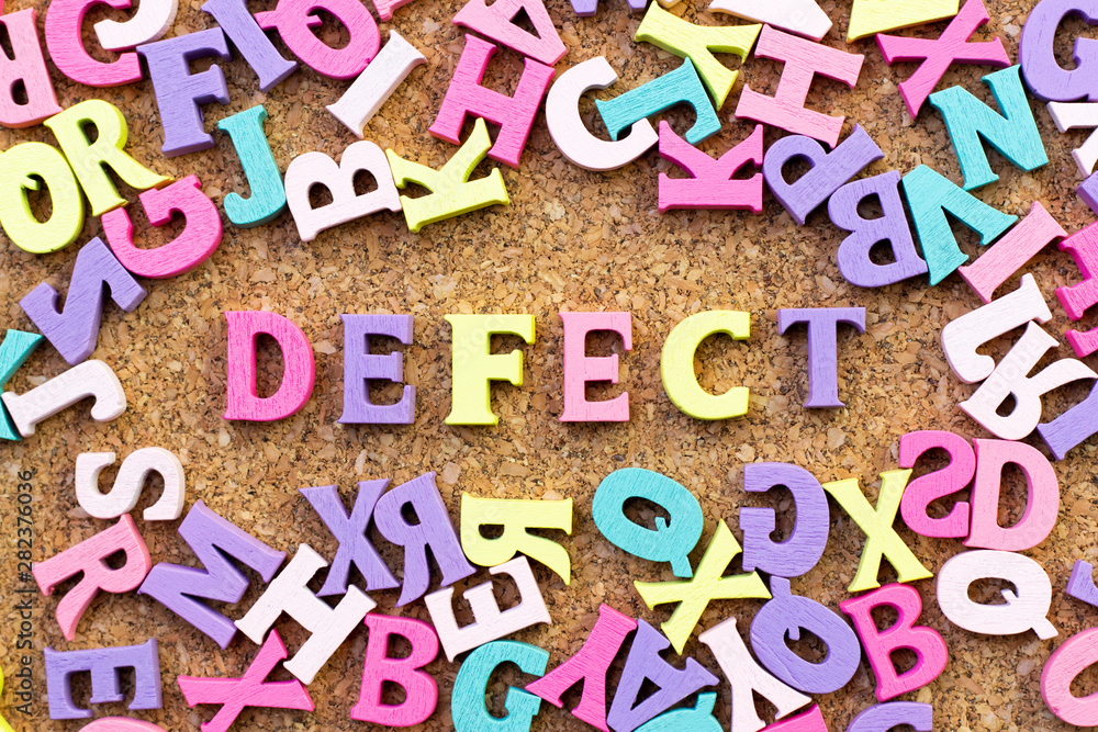 Color alphabet in word defect with another letter as frame on cork ...