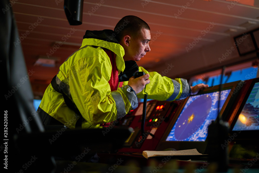 Navigator. pilot, captain as pat of ship crew performing daily duties ...