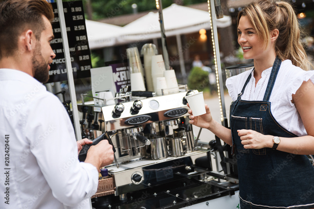 Beautiful woman barista selling coffee to the customer Stock Photo ... Beautiful woman barista selling coffee to the customer Stock Photo ...